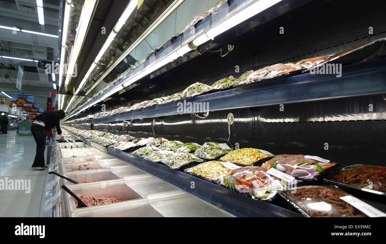 A customer buys at a supermarket in Xiangfan, Hubei province April 26 ...