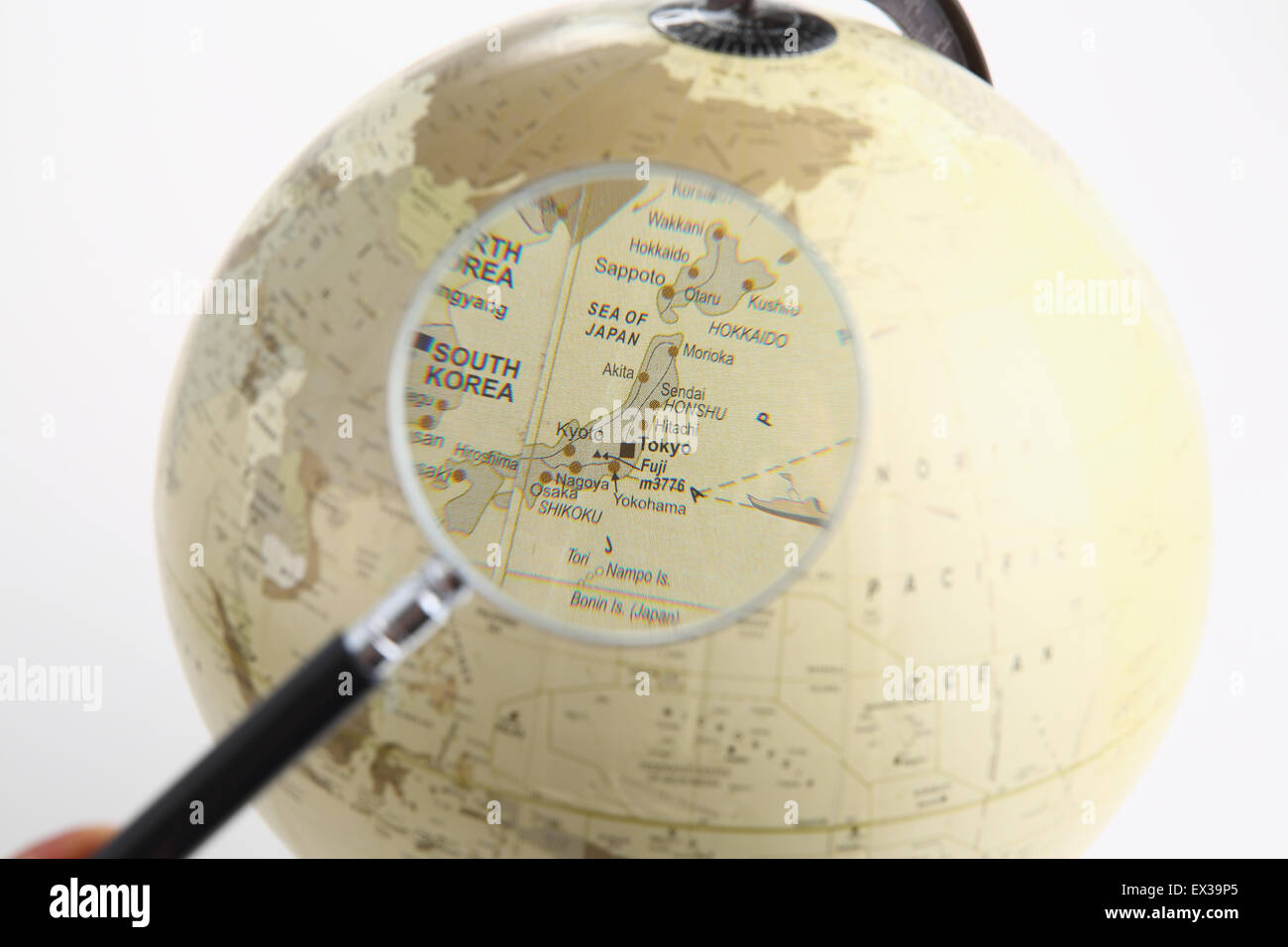 World globe and magnifying glass Stock Photo - Alamy