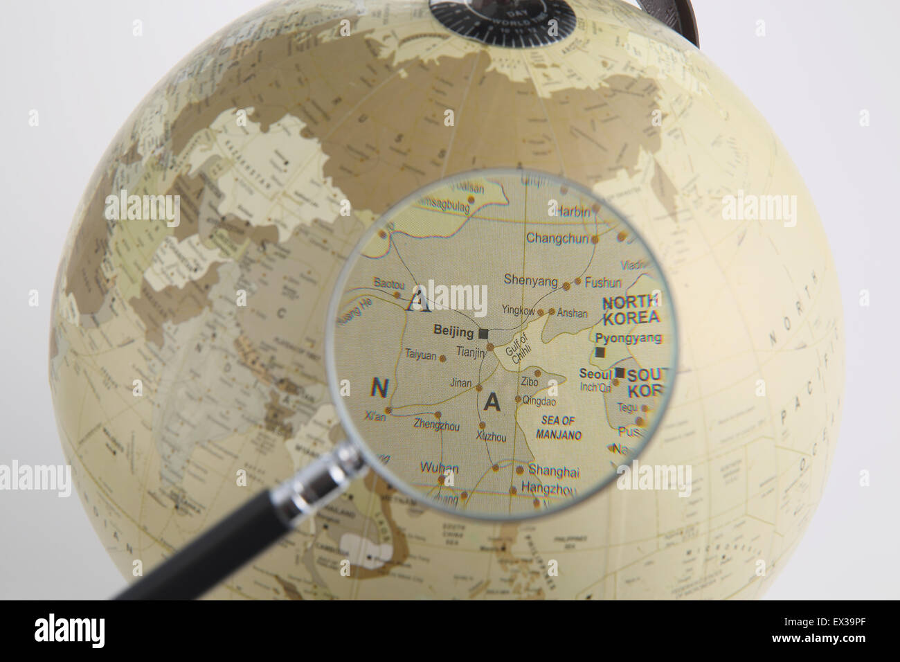 World globe and magnifying glass Stock Photo - Alamy