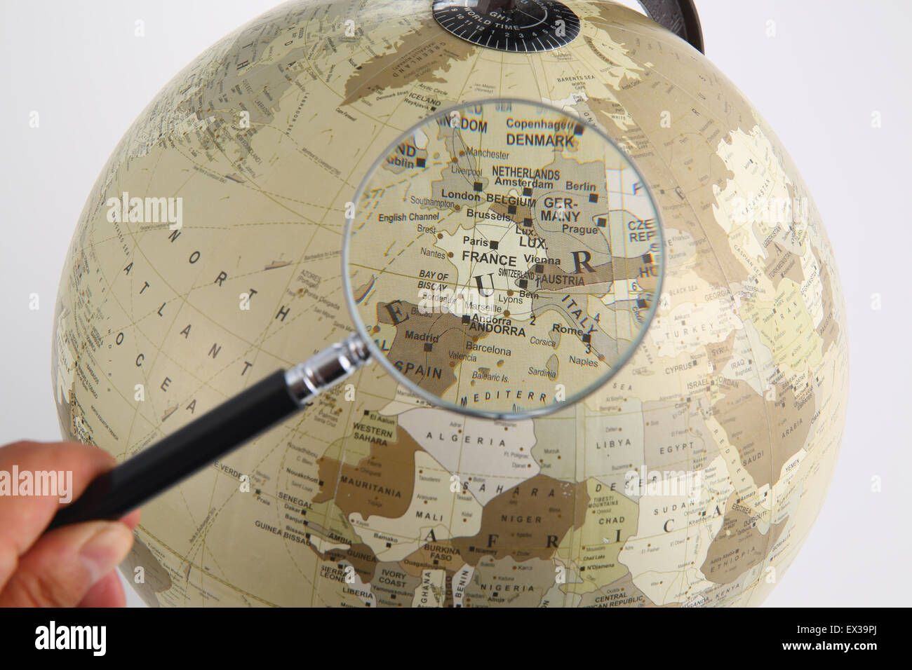 World globe and magnifying glass Stock Photo - Alamy