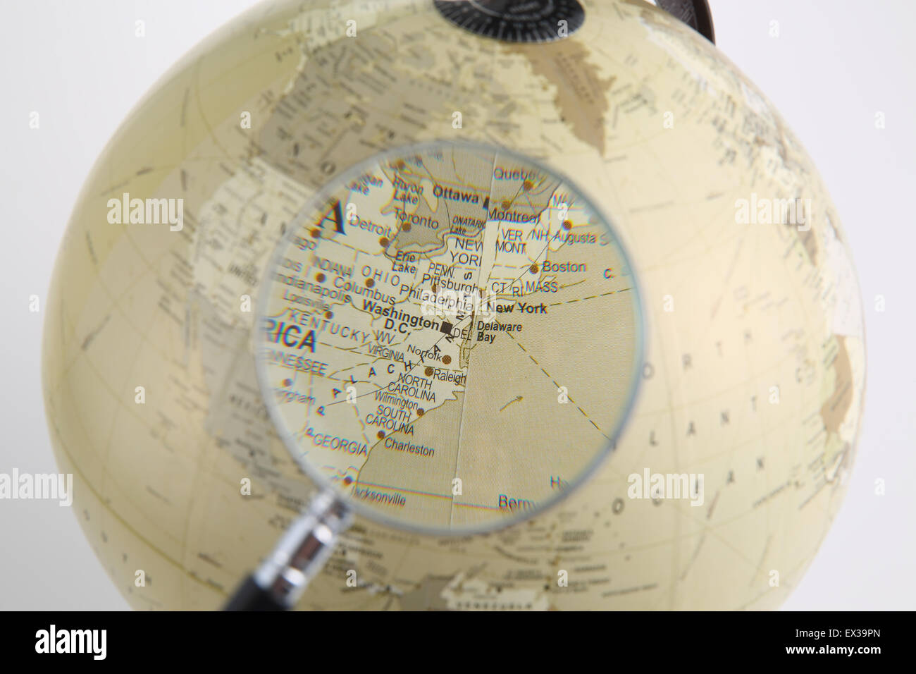 World globe and magnifying glass Stock Photo - Alamy