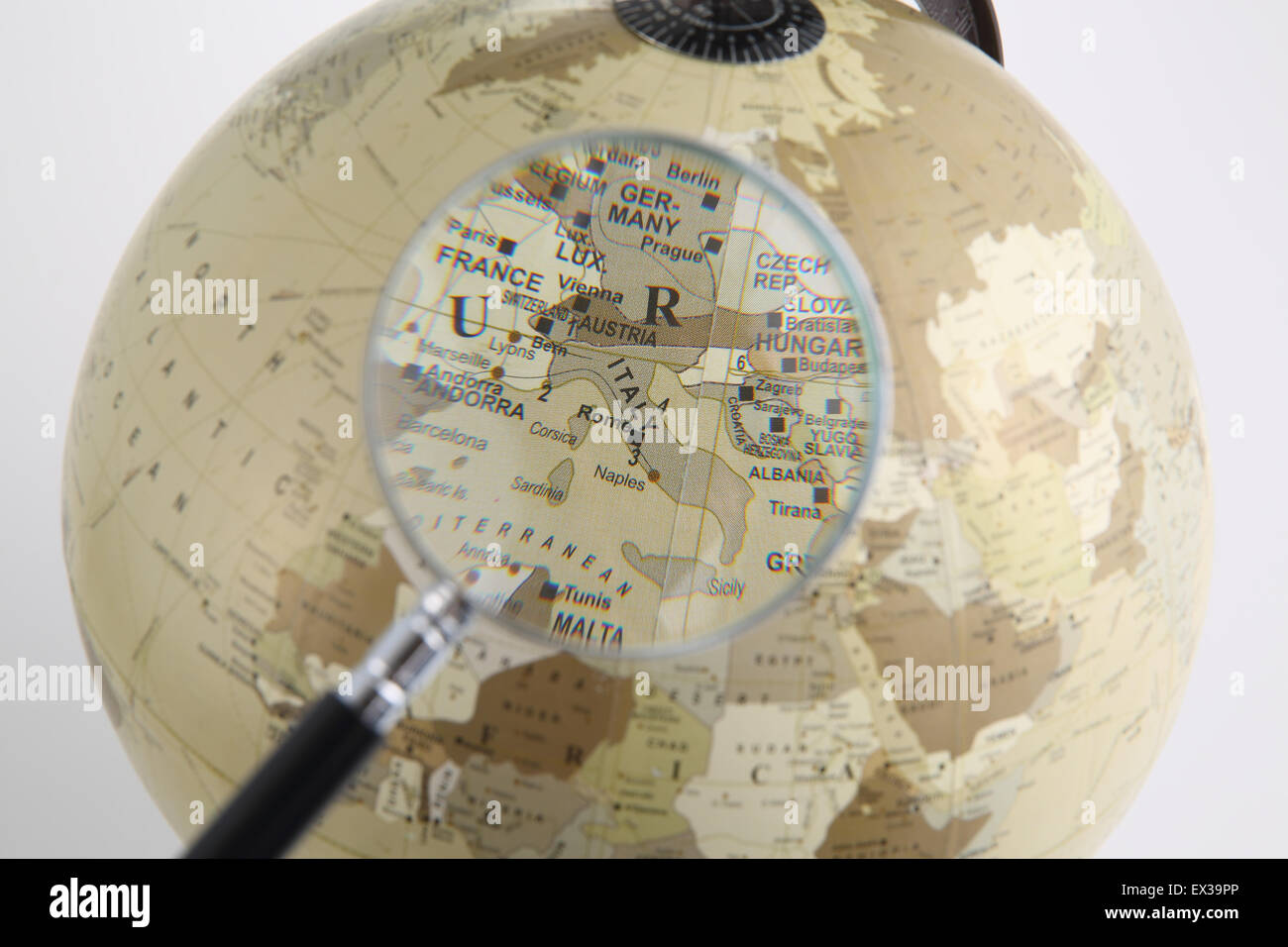 World globe and magnifying glass Stock Photo - Alamy
