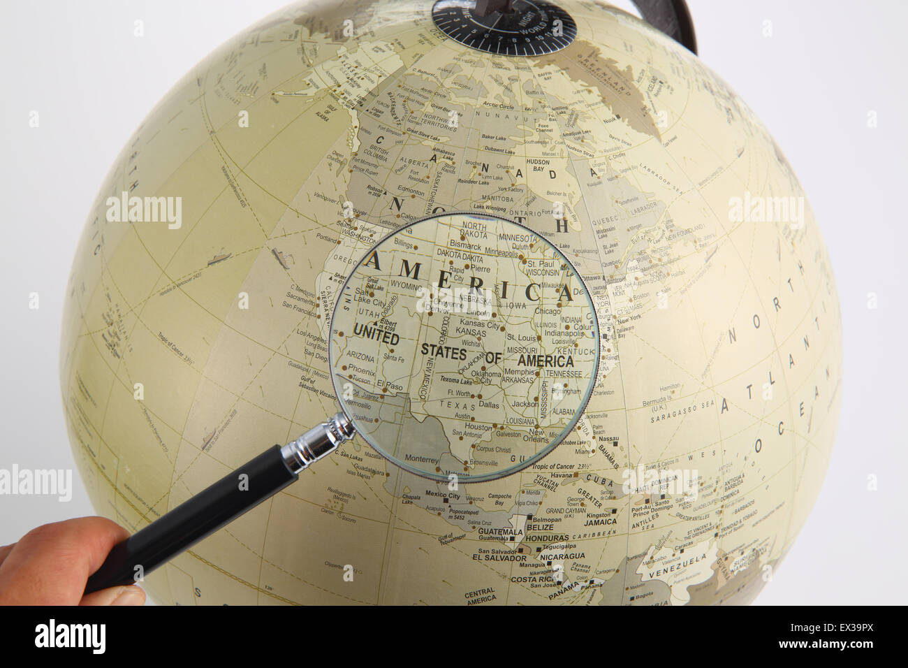 World globe and magnifying glass Stock Photo - Alamy