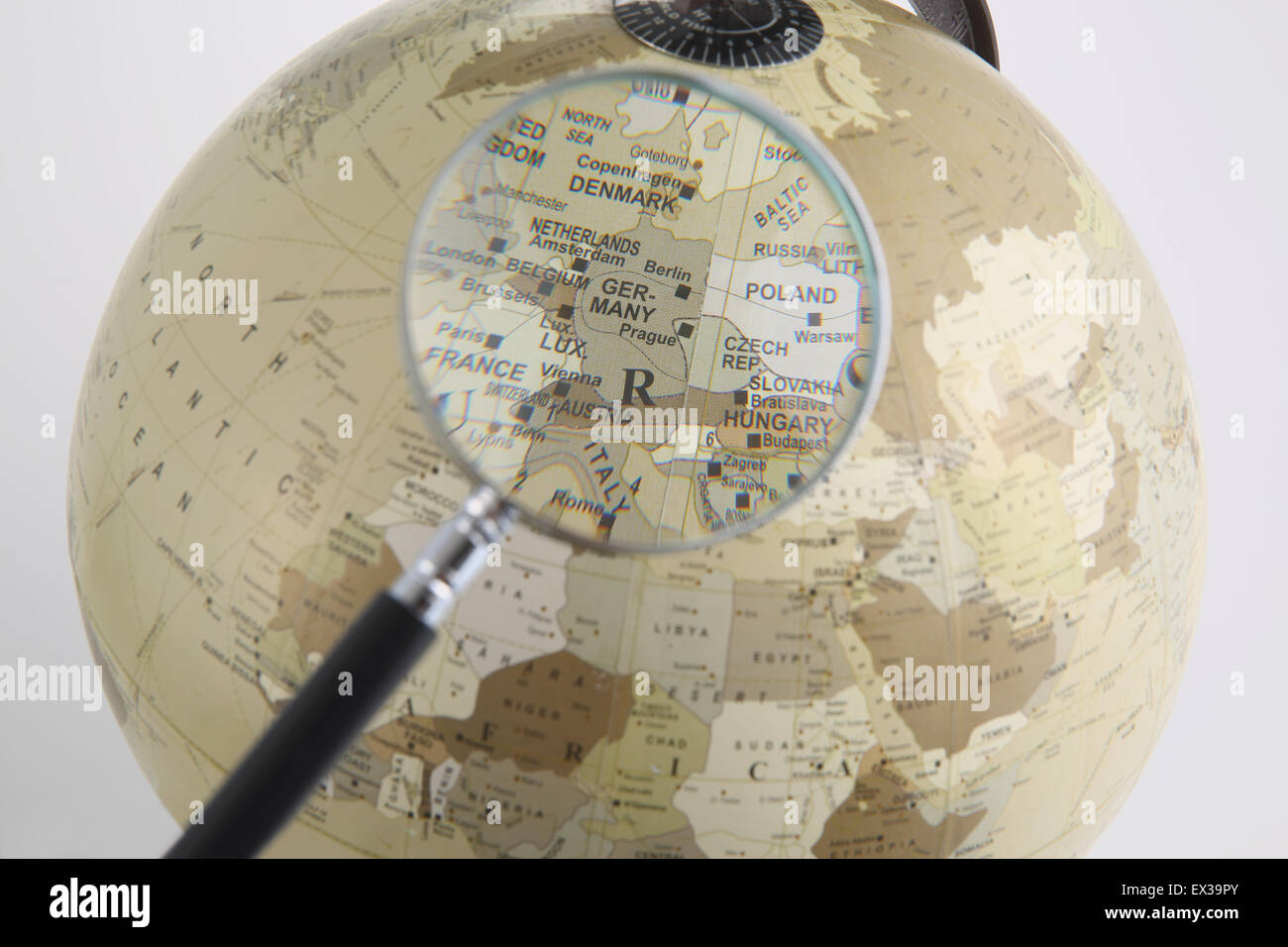 World globe and magnifying glass Stock Photo - Alamy
