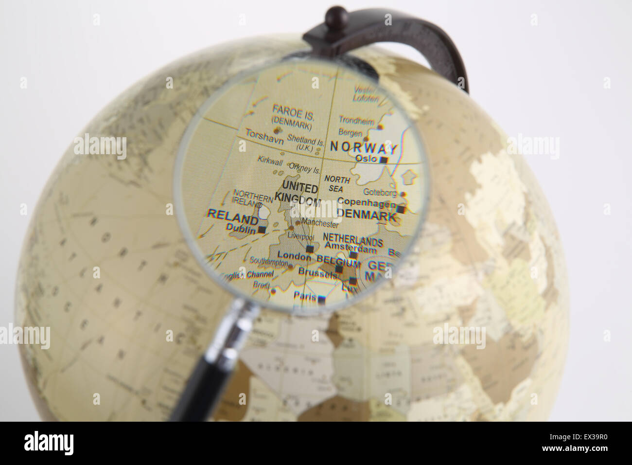 World globe and magnifying glass Stock Photo - Alamy