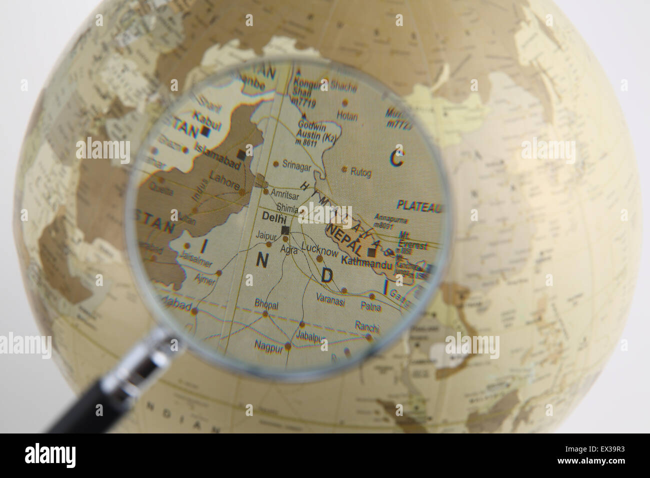 World globe and magnifying glass Stock Photo - Alamy