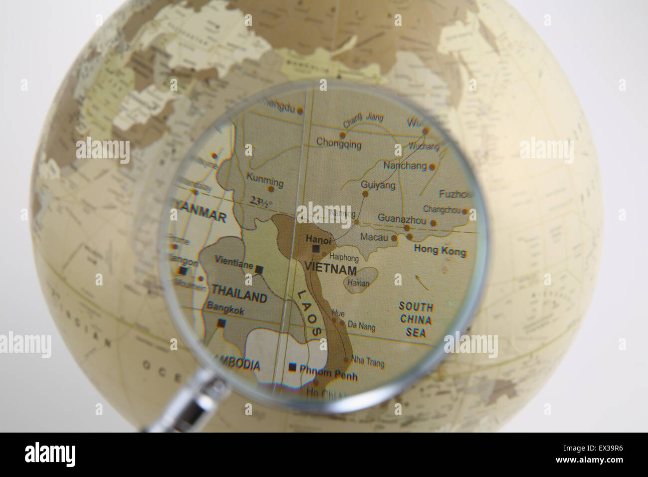 World globe and magnifying glass Stock Photo - Alamy
