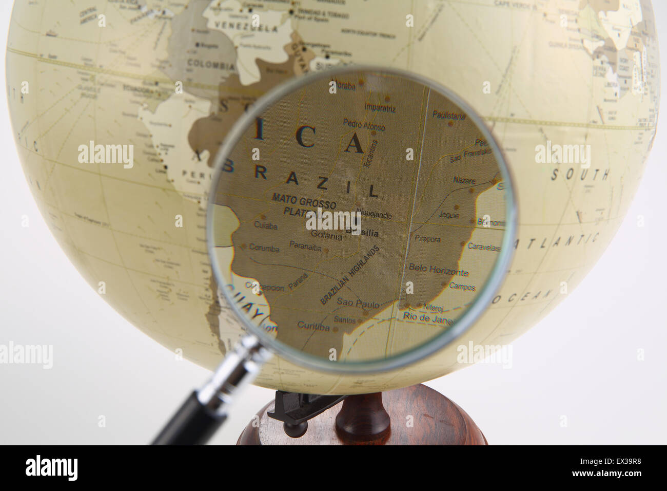 World globe and magnifying glass Stock Photo - Alamy
