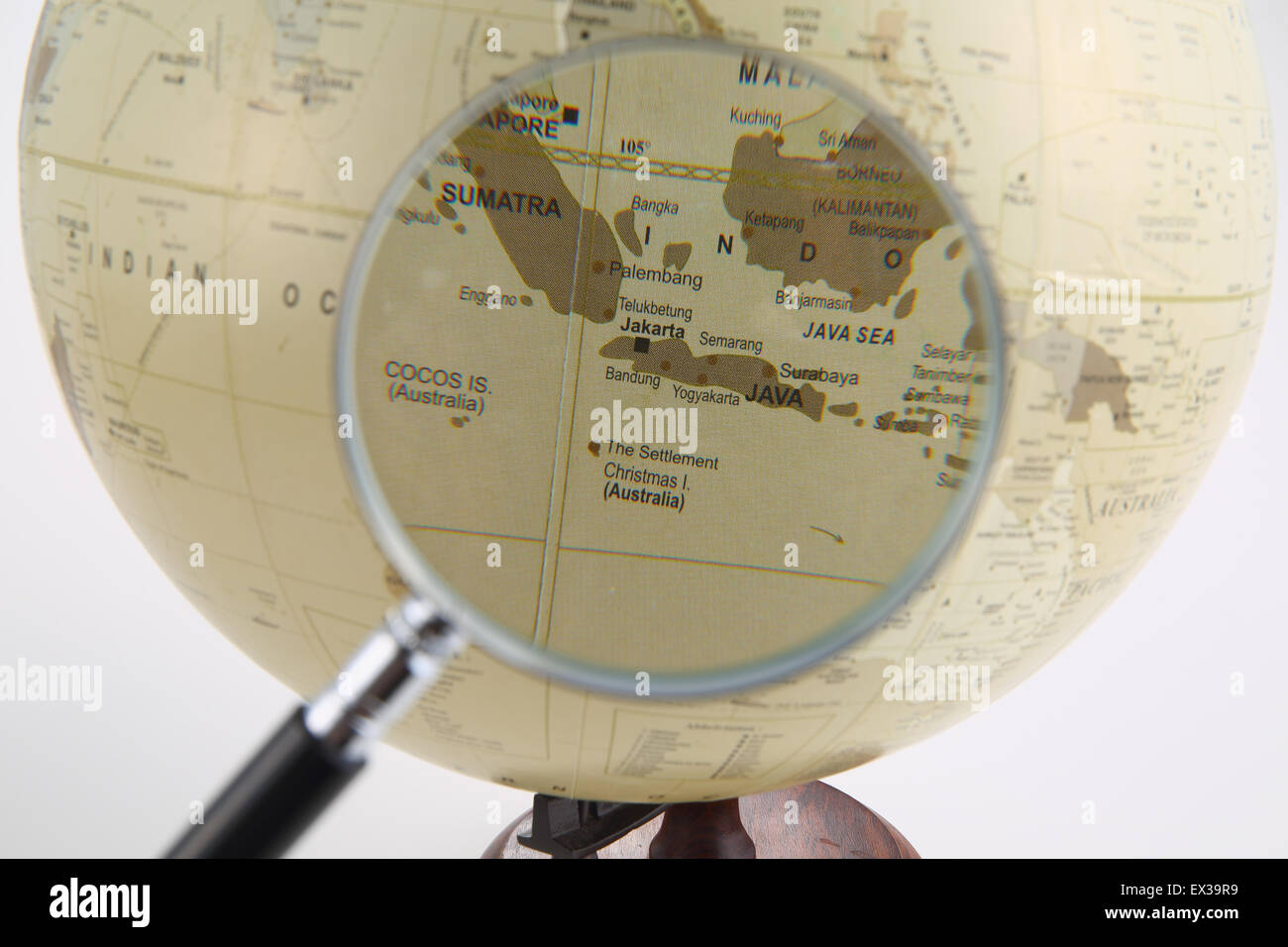 World globe and magnifying glass Stock Photo - Alamy