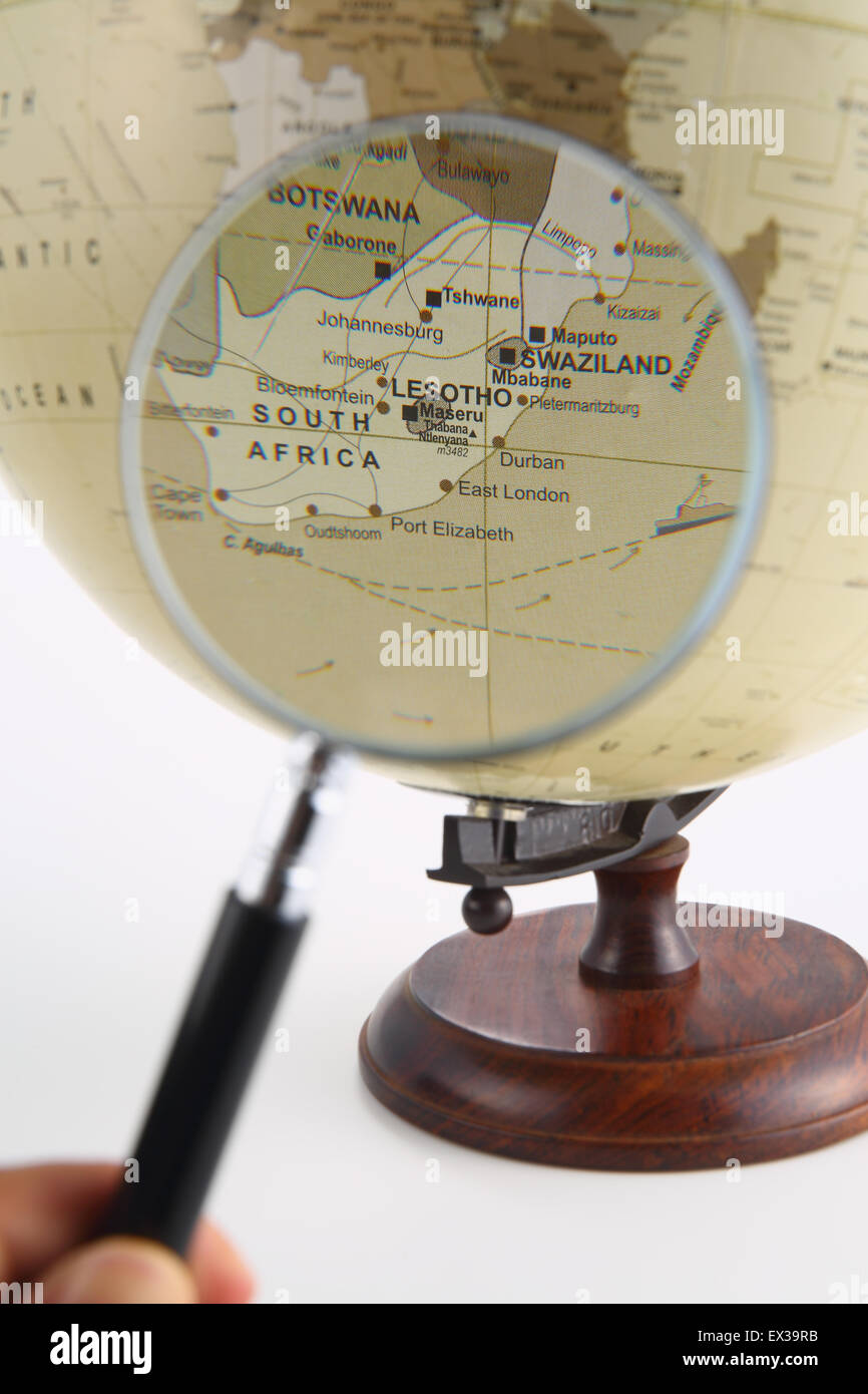 World globe and magnifying glass Stock Photo - Alamy