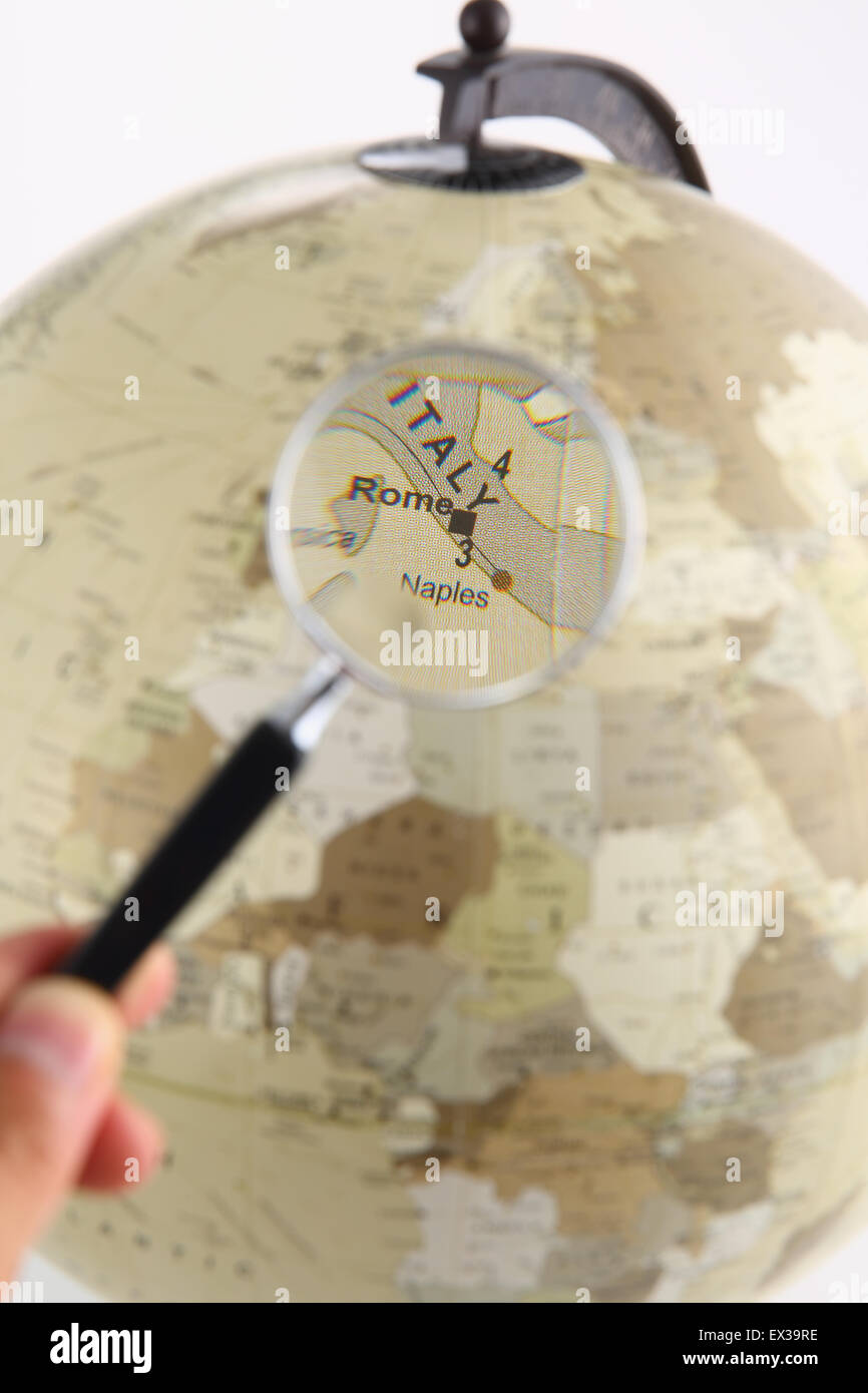 World globe and magnifying glass Stock Photo - Alamy