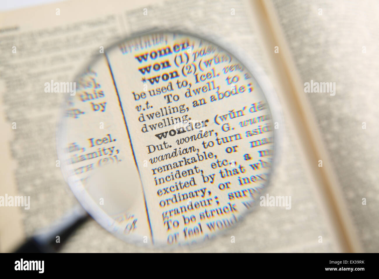 Dictionary and magnifying glass Stock Photo - Alamy