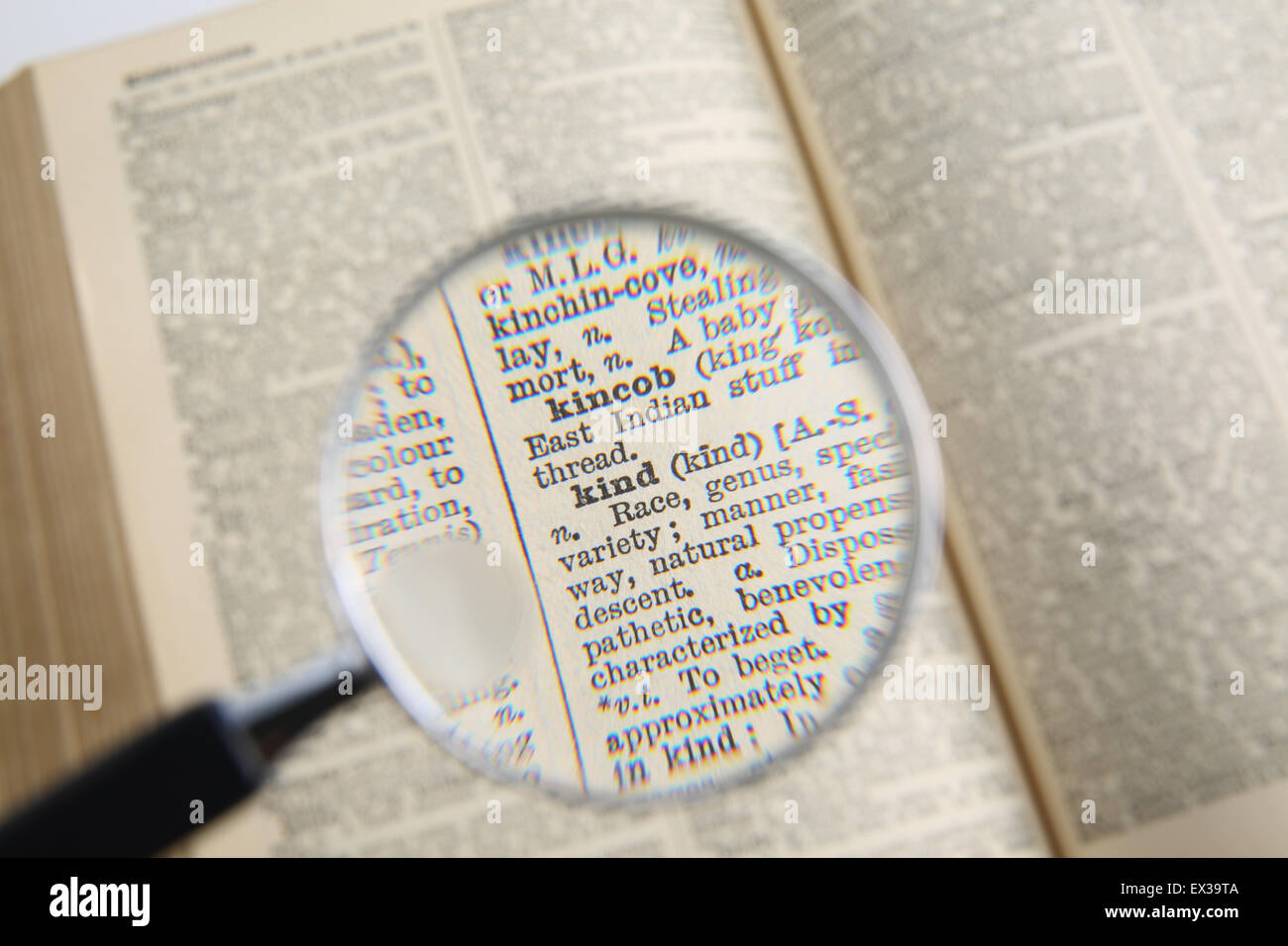 Dictionary and magnifying glass Stock Photo - Alamy