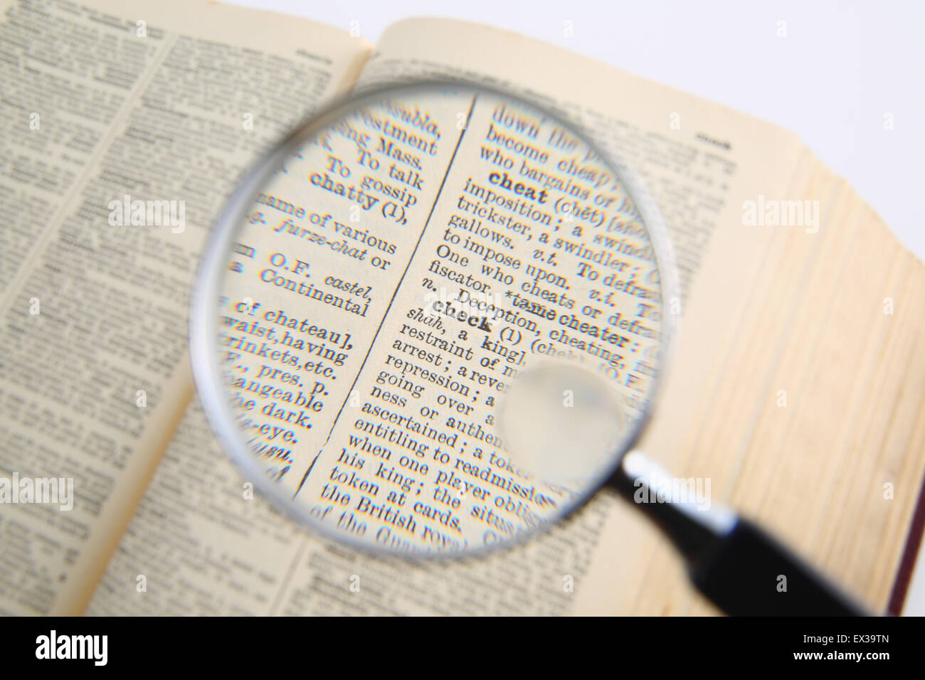 Dictionary and magnifying glass Stock Photo - Alamy