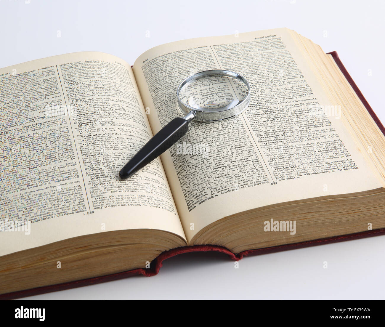 Dictionary and magnifying glass Stock Photo - Alamy