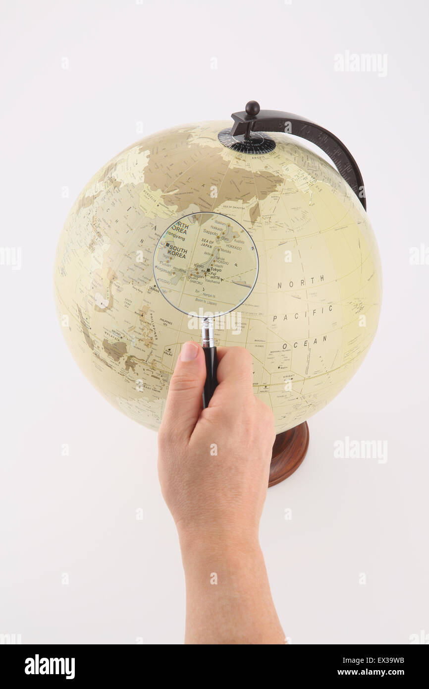 World globe and magnifying glass Stock Photo - Alamy