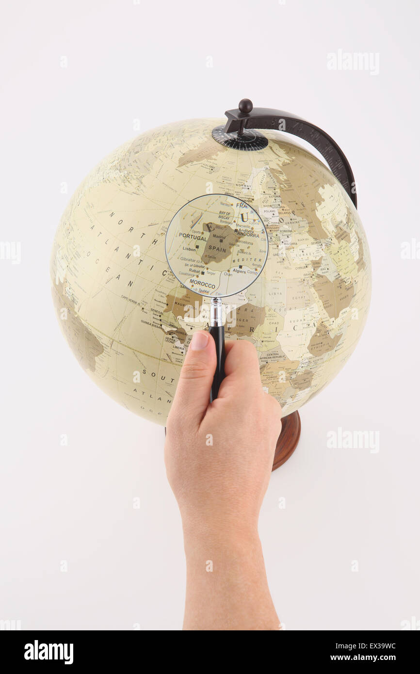 World globe and magnifying glass Stock Photo - Alamy