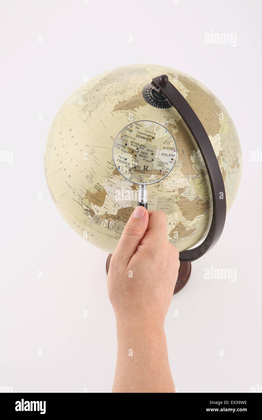 World globe and magnifying glass Stock Photo - Alamy