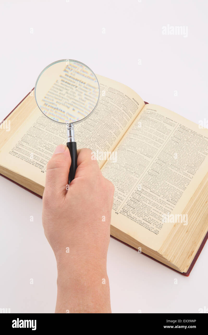 Dictionary and magnifying glass Stock Photo - Alamy