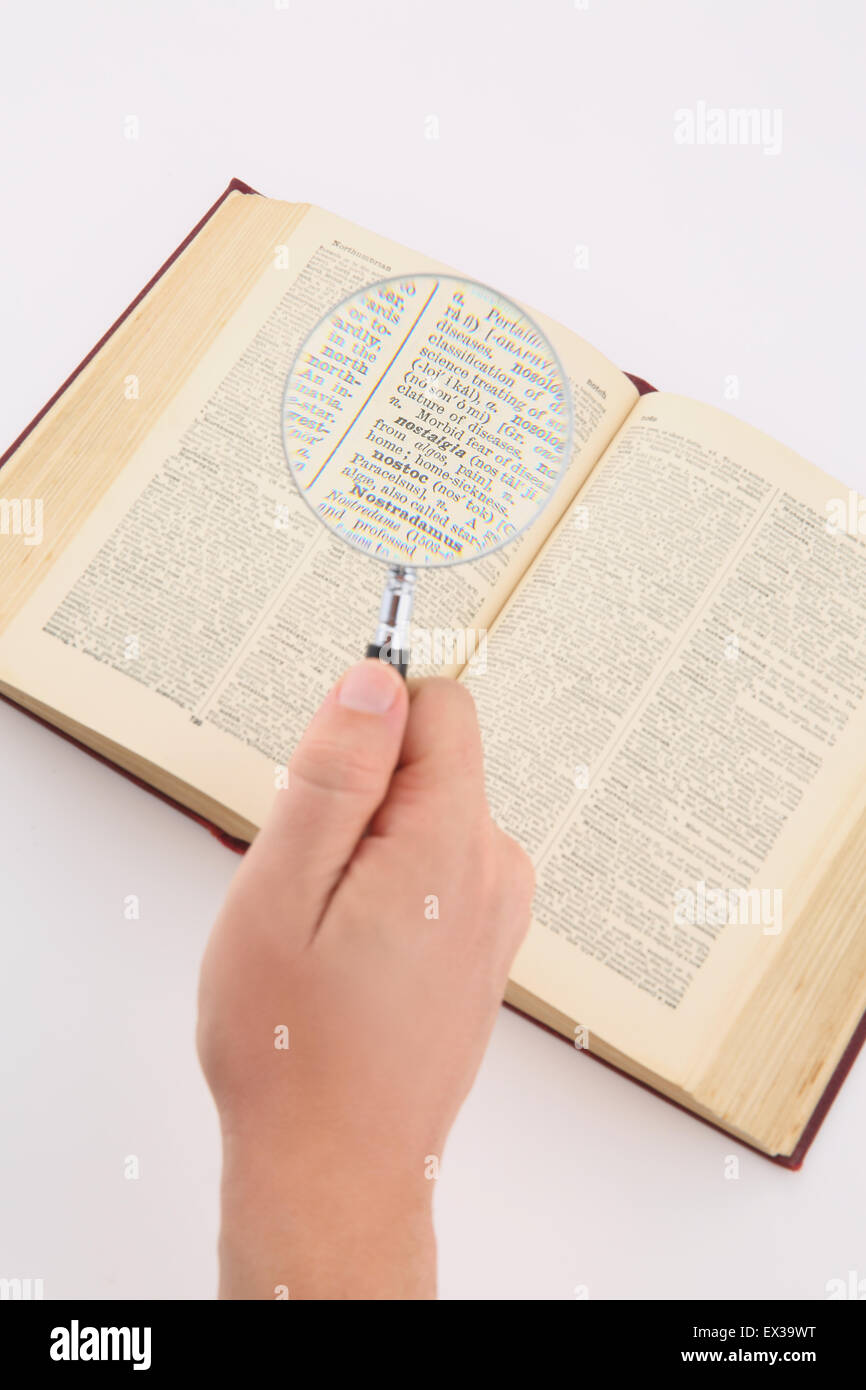 Dictionary and magnifying glass Stock Photo - Alamy