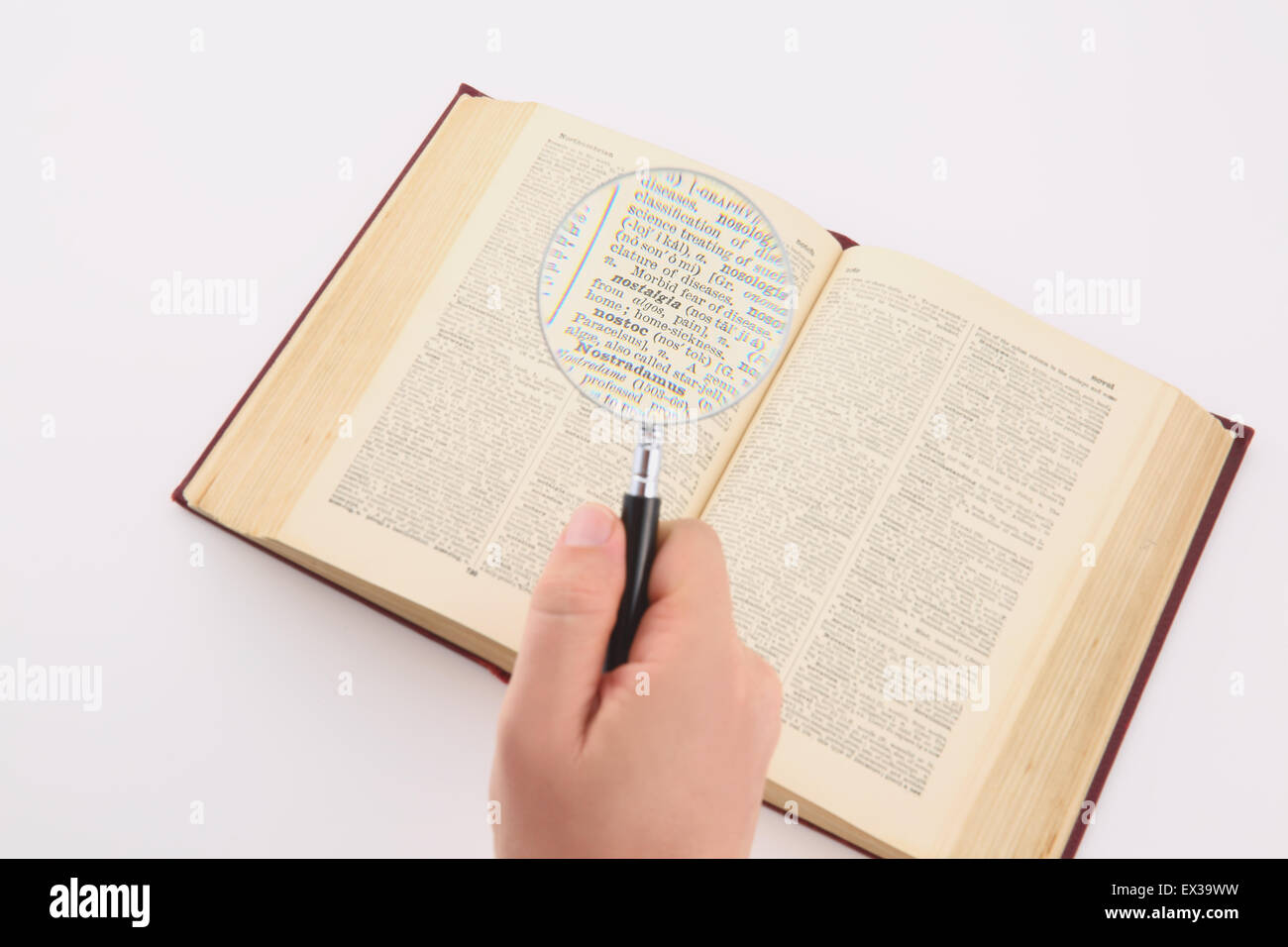 Dictionary and magnifying glass Stock Photo - Alamy