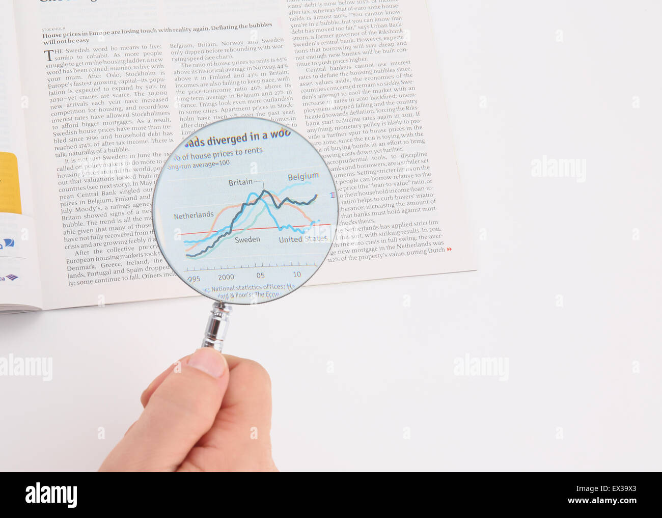 Newspaper and magnifying glass Stock Photo - Alamy