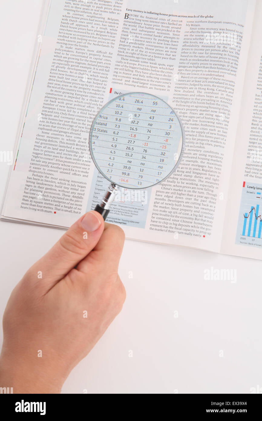 Newspaper and magnifying glass Stock Photo - Alamy