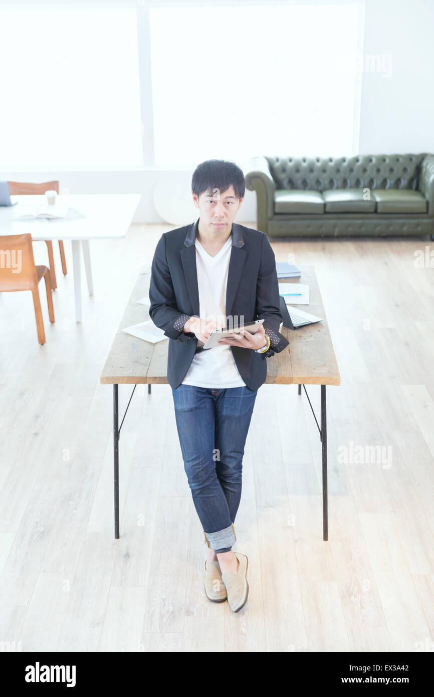 Japanese man working in modern office Stock Photo - Alamy