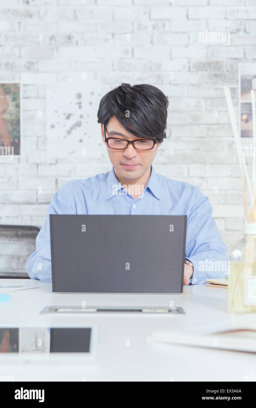 Japanese man working in modern office Stock Photo - Alamy
