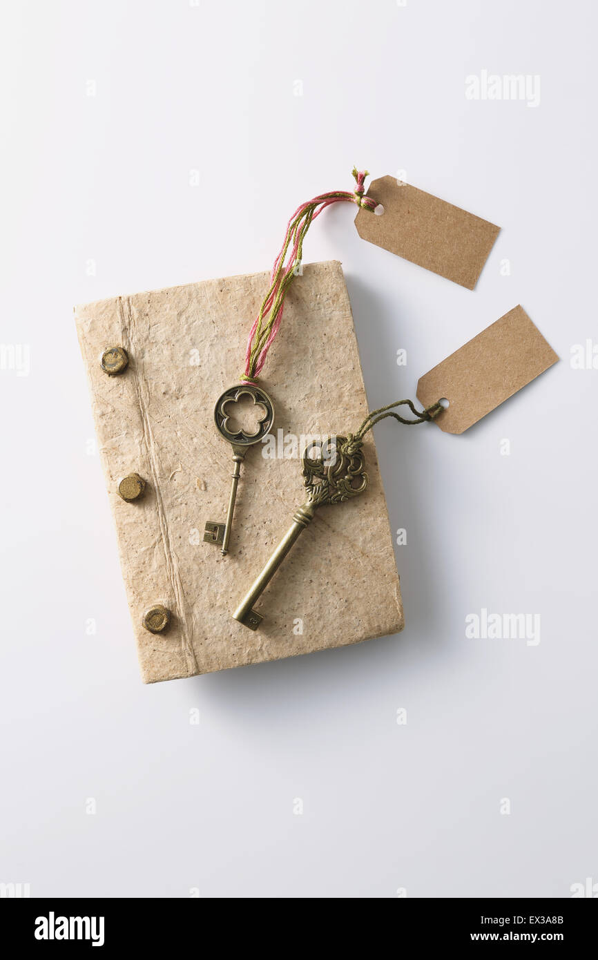 Vintage keys and book Stock Photo - Alamy