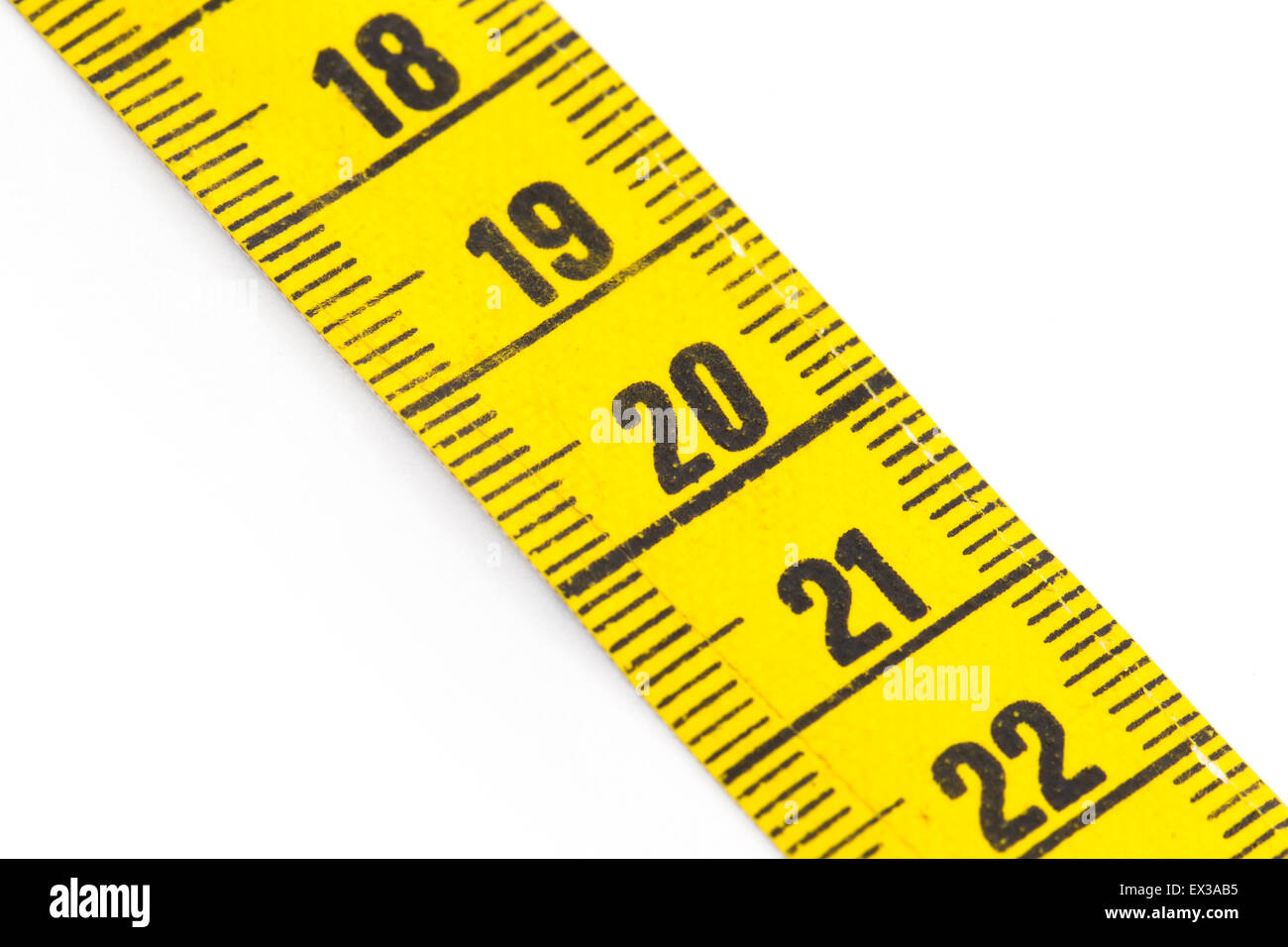 Yellow measuring tape isolated on white background - selective focus ...