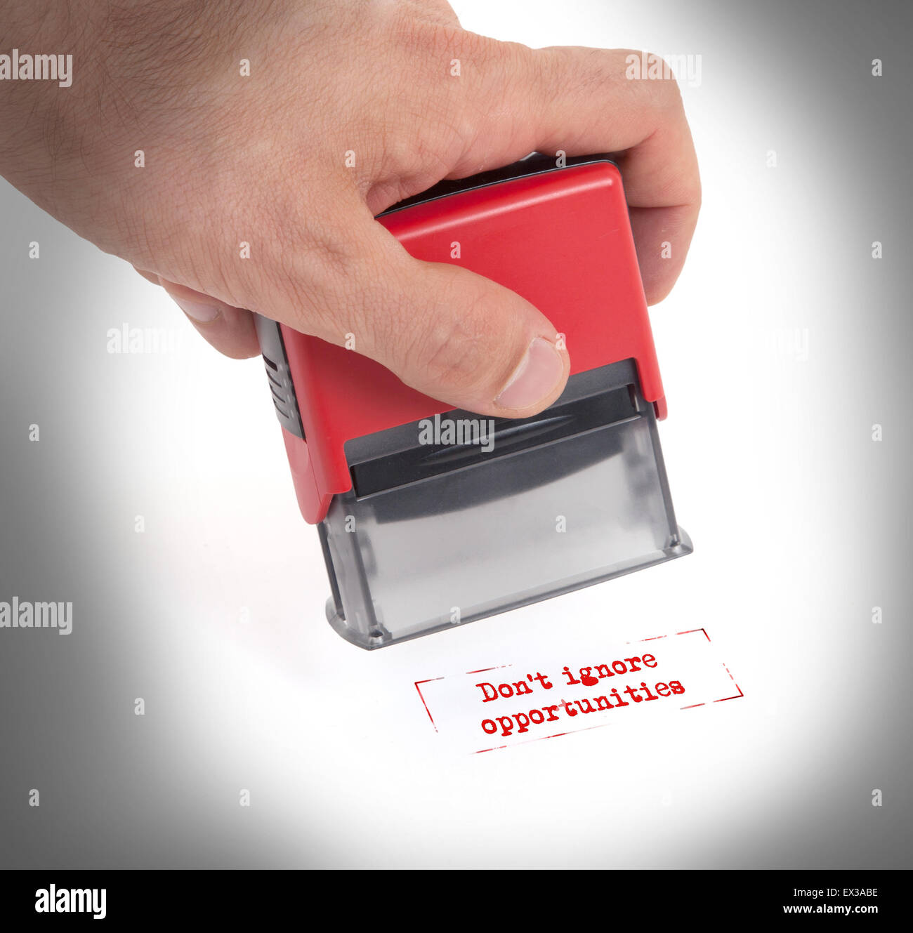 Plastic stamp in hand, isolated on white - Don't ignore opportunities ...