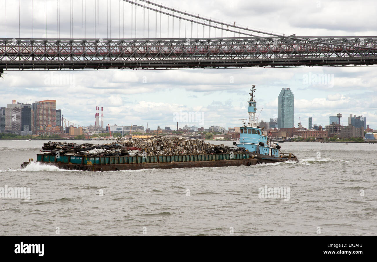 Tug and barge full of scrap metal for recycling on the East River ...