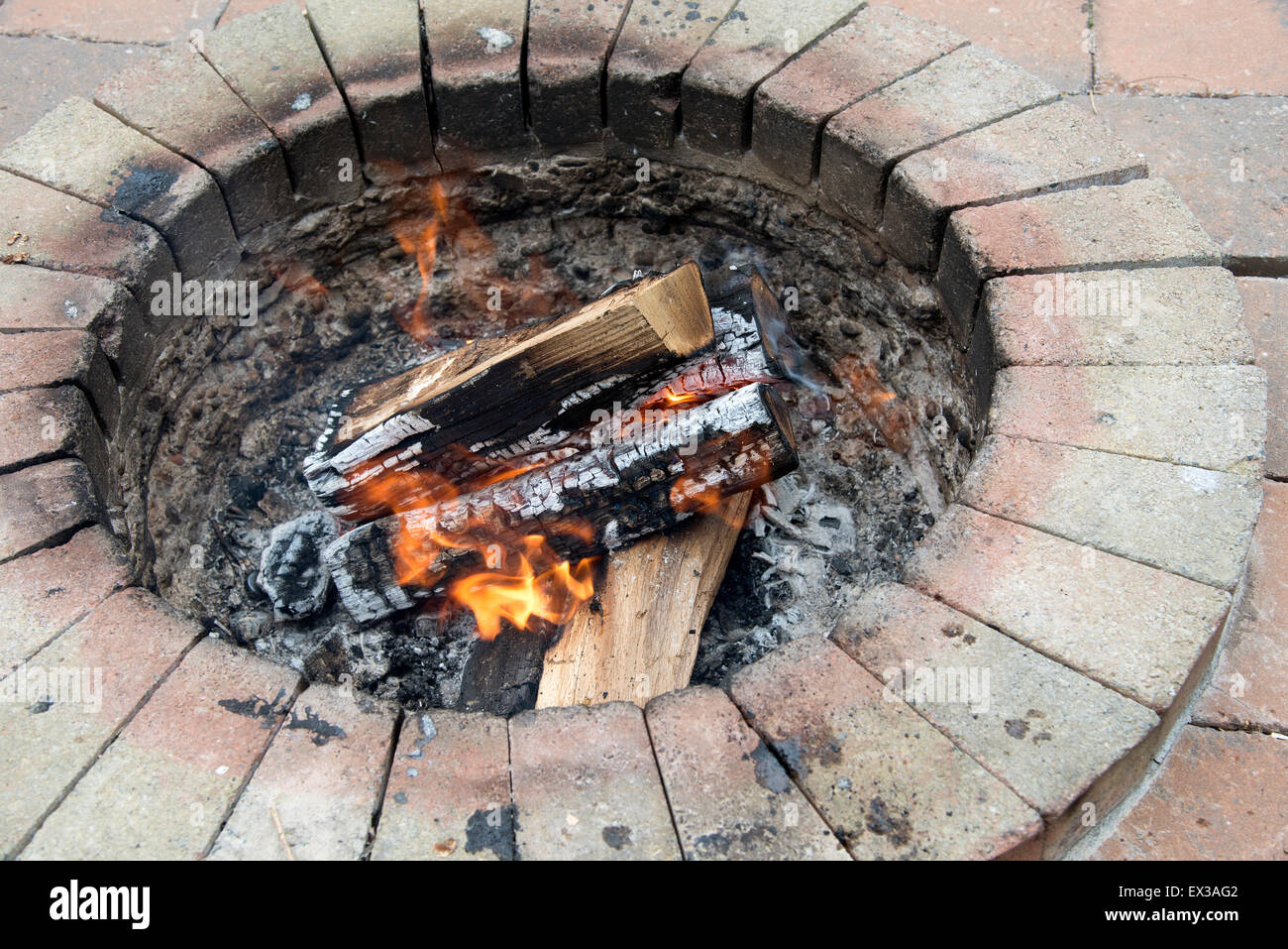 Burning wood in a garden fire pit almost ready to cook on Stock Photo ...