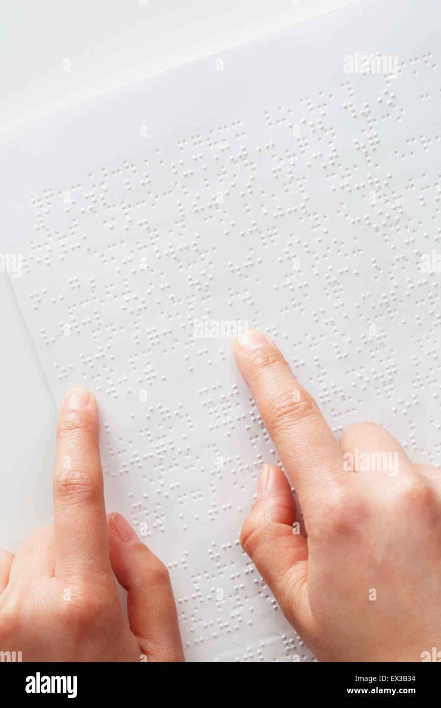 Hands reading Braille paper Stock Photo - Alamy