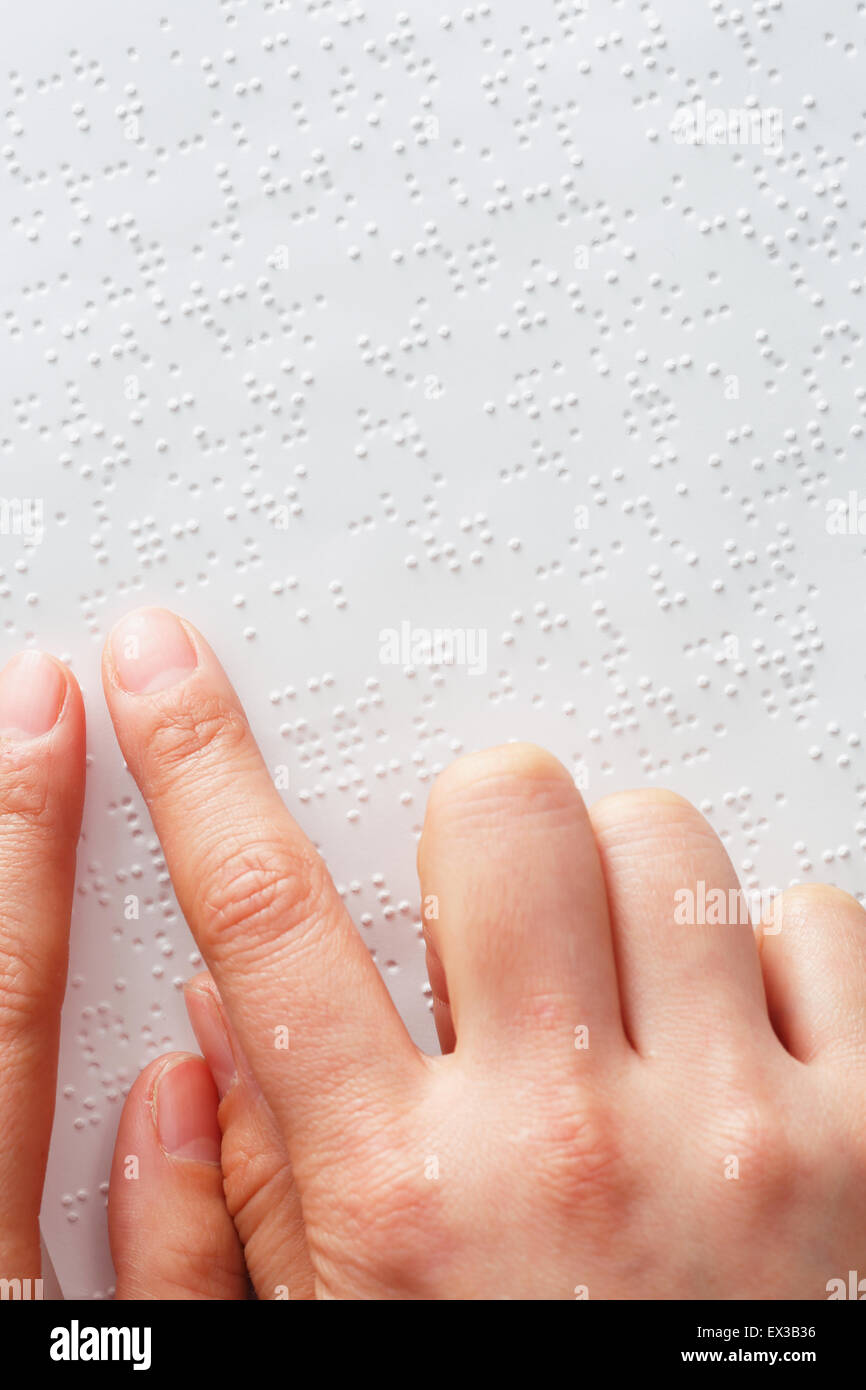 Hands reading Braille paper Stock Photo - Alamy