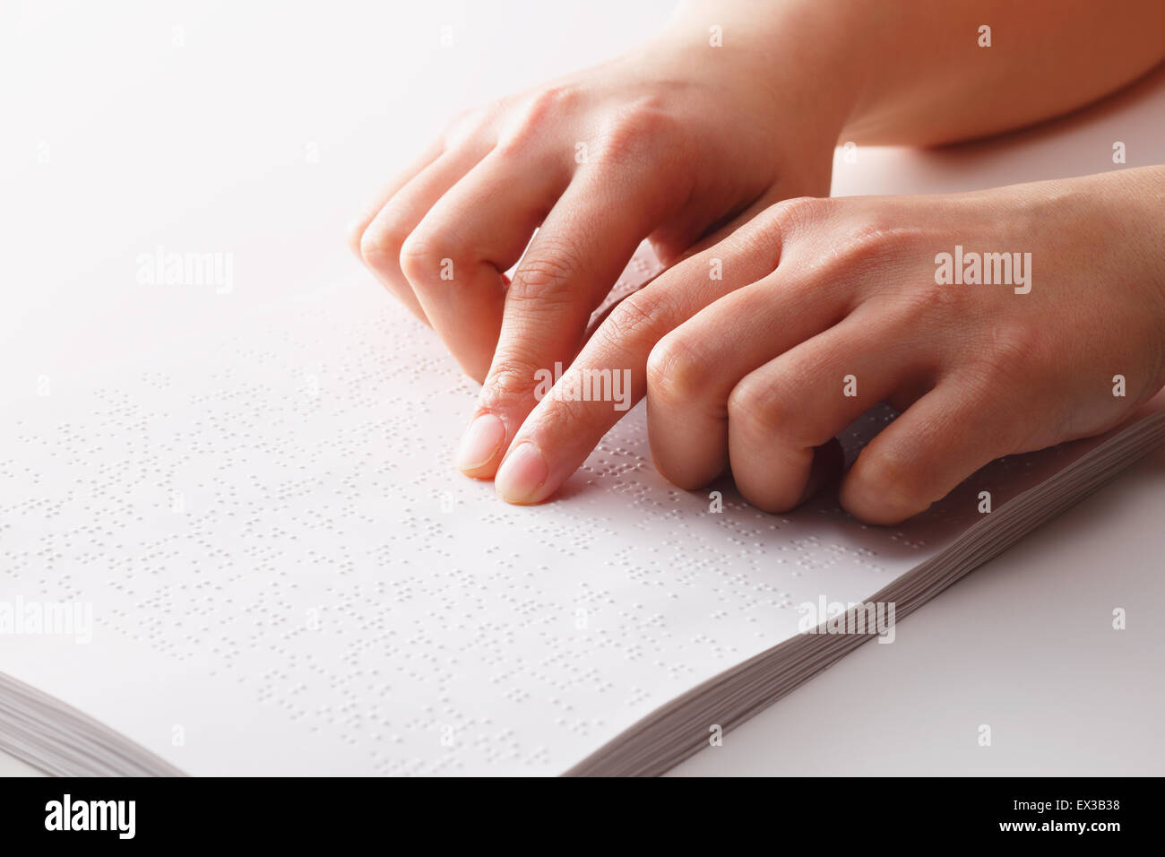 Hands reading Braille paper Stock Photo - Alamy