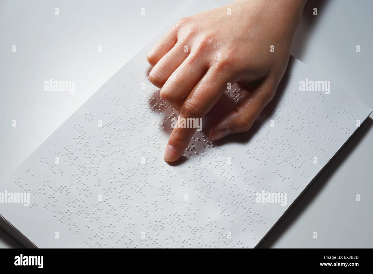 Hand reading Braille paper Stock Photo - Alamy