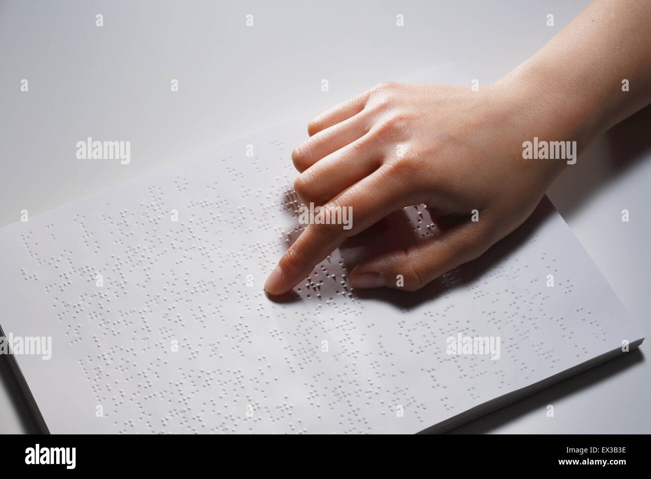Hand reading Braille paper Stock Photo - Alamy