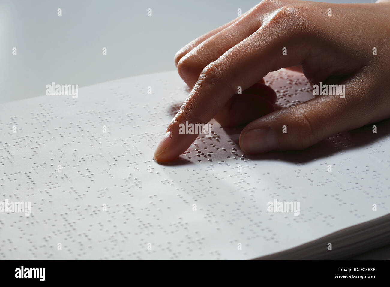 Hand reading Braille paper Stock Photo - Alamy