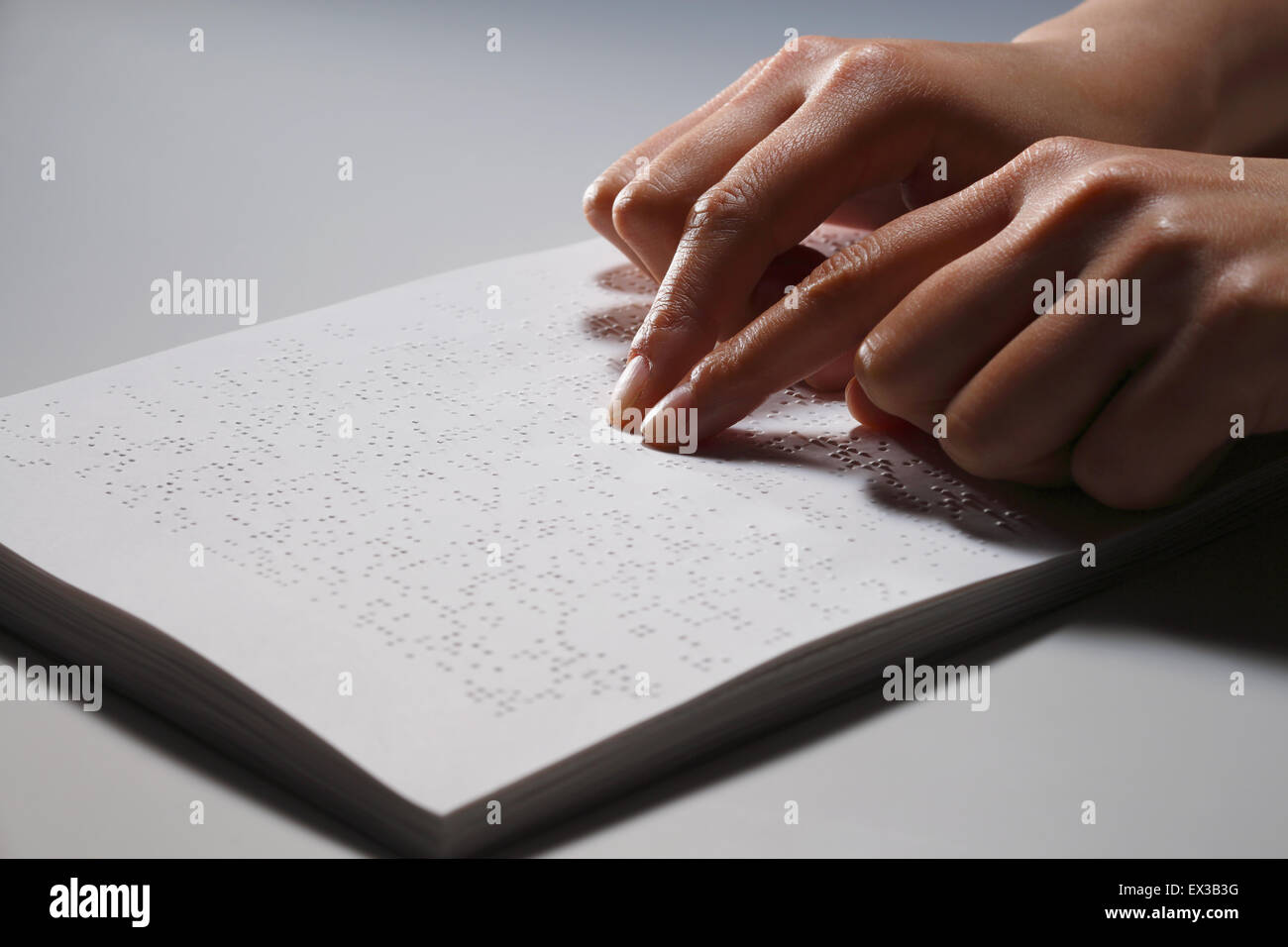Hands reading Braille paper Stock Photo - Alamy