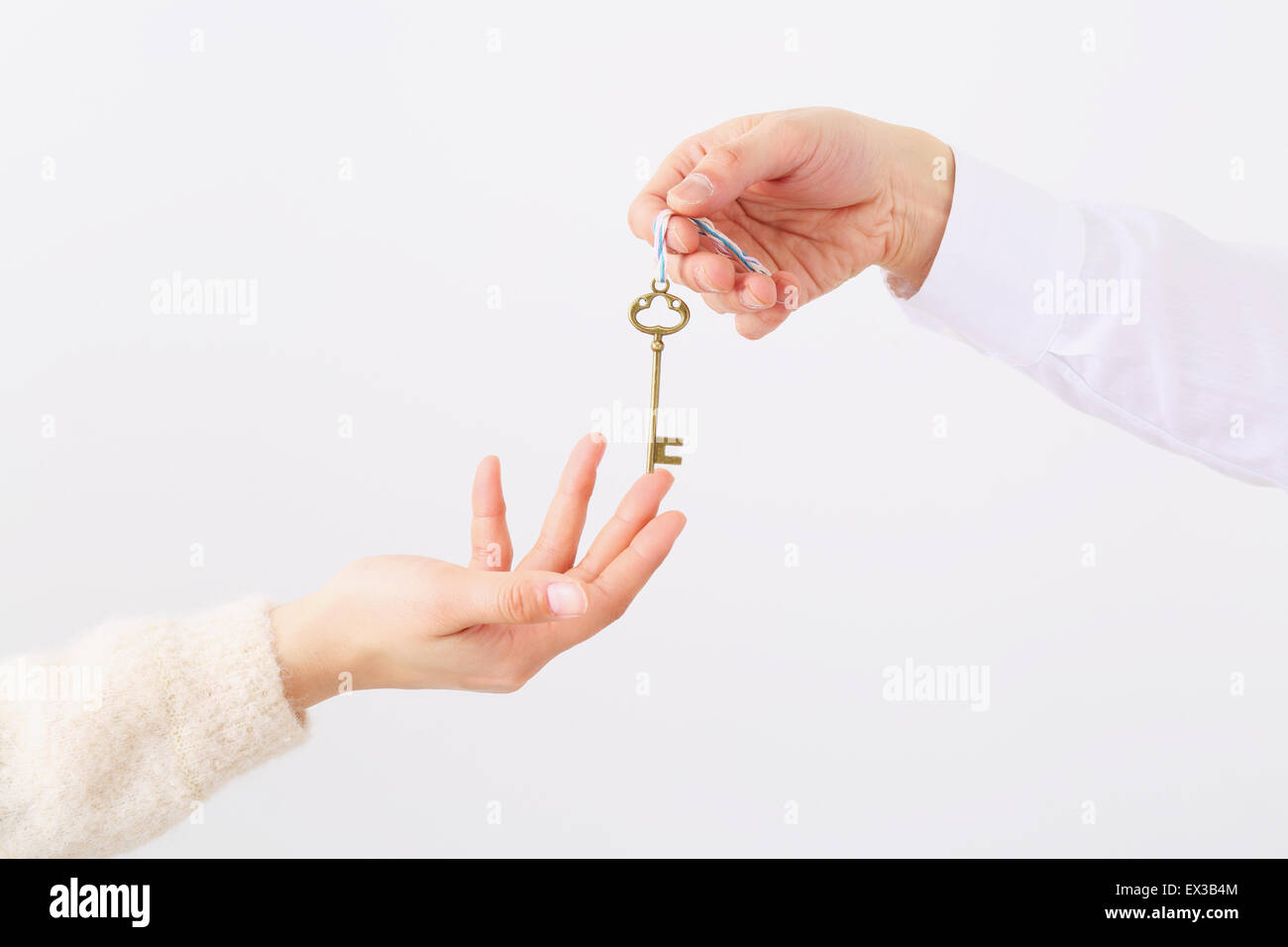 Man and woman hands passing key Stock Photo - Alamy