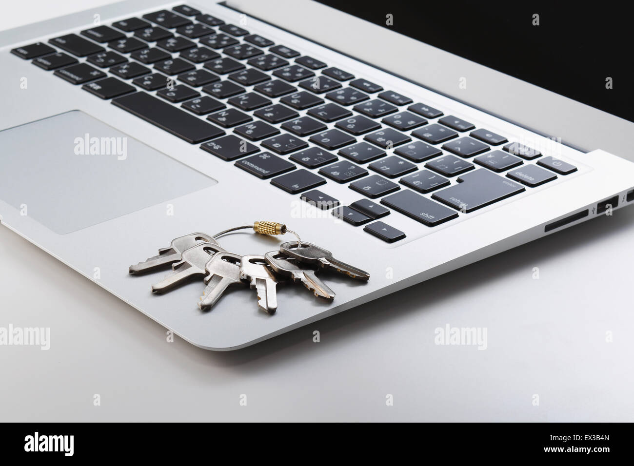 Keys and laptop Stock Photo - Alamy