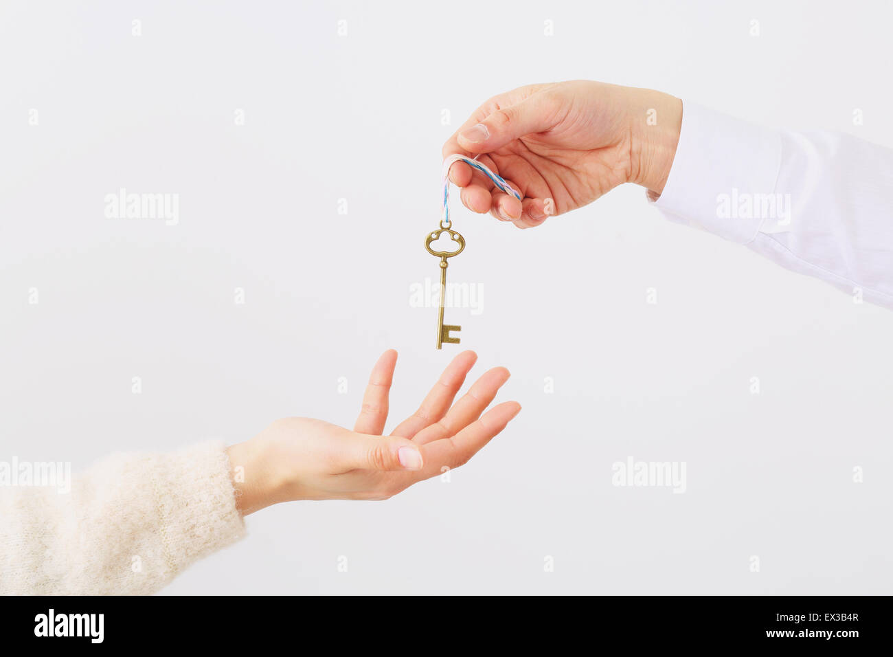Man and woman hands passing key Stock Photo - Alamy