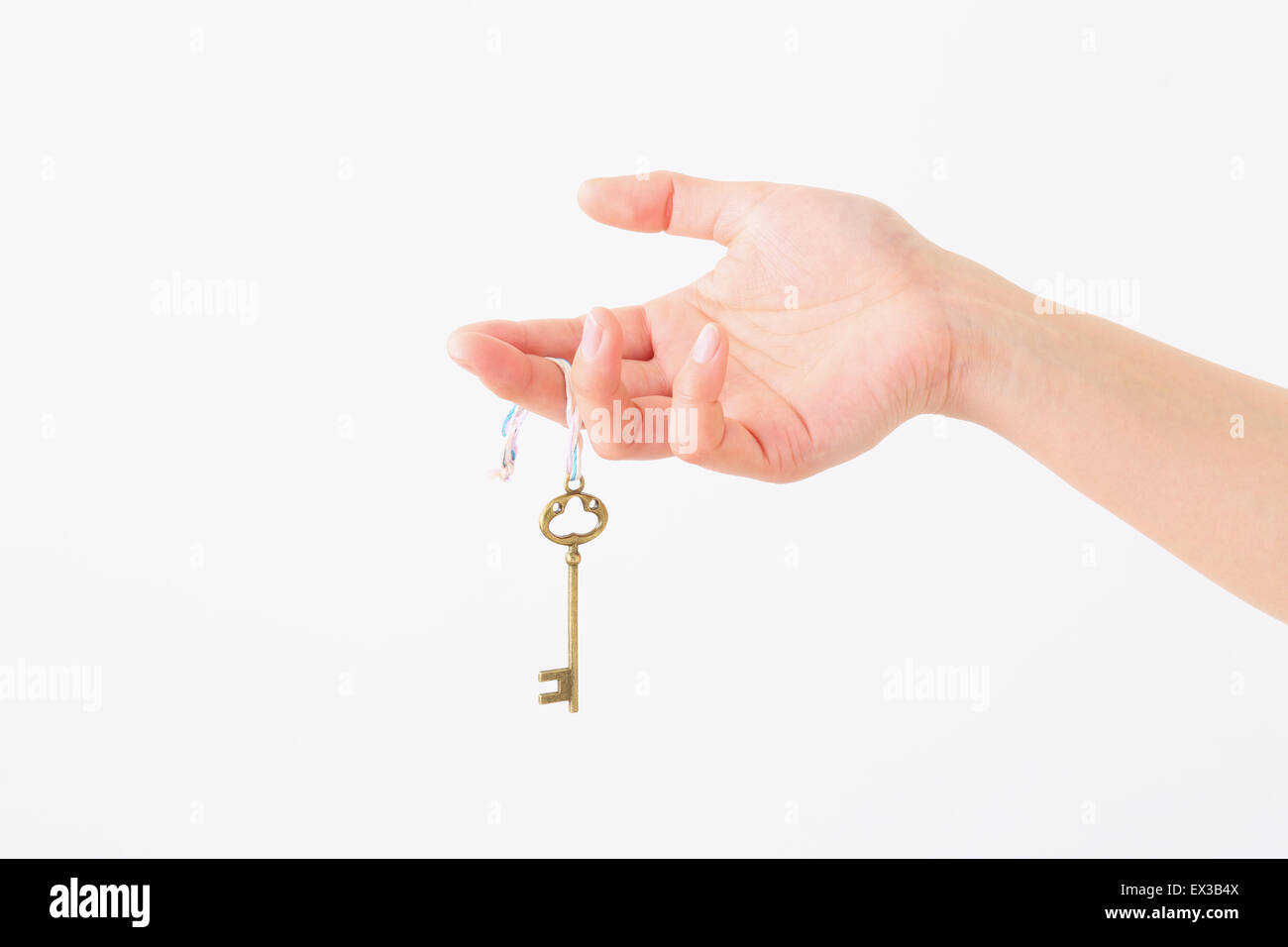 Young woman holding key Stock Photo - Alamy