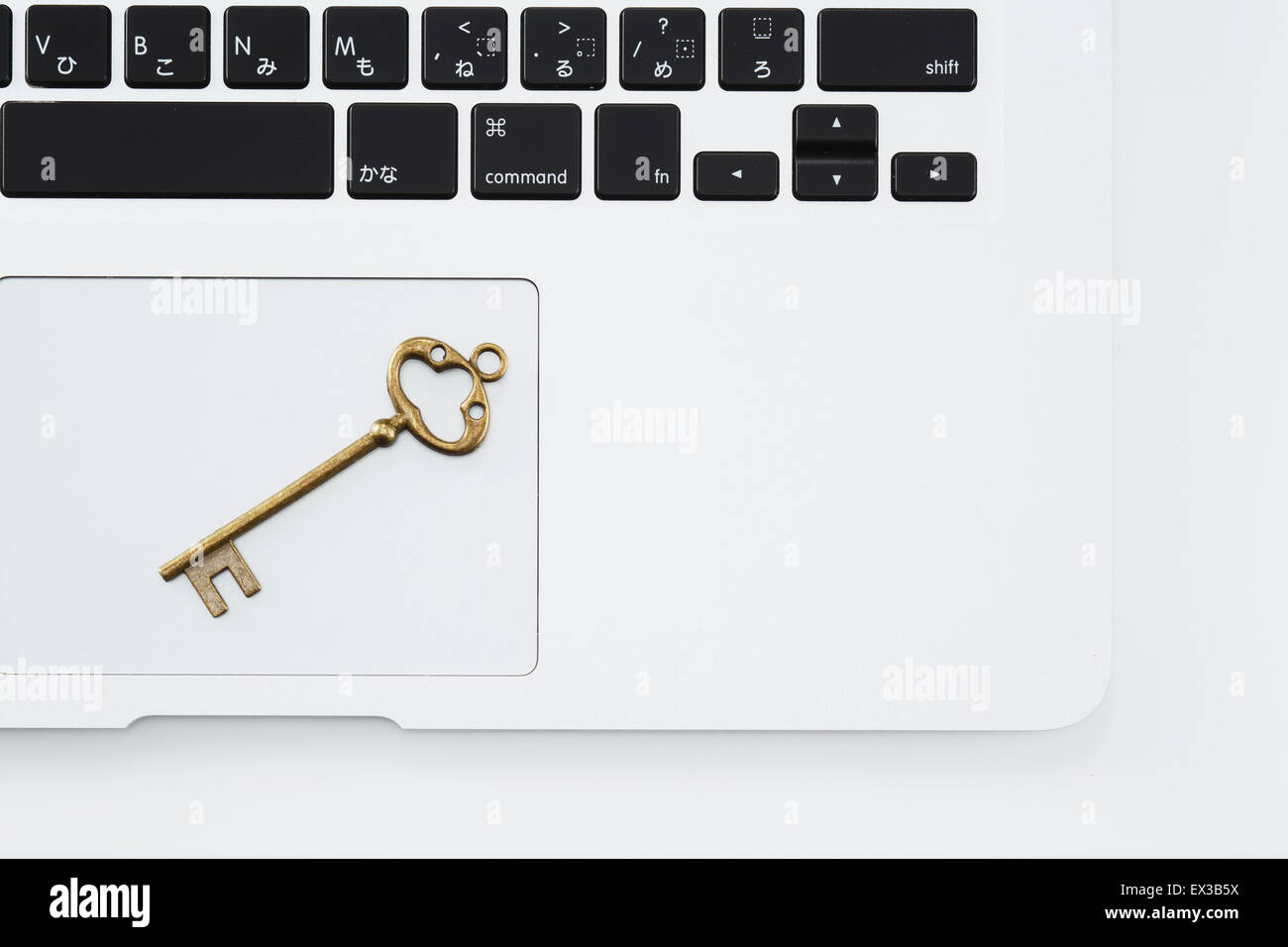 Key and laptop Stock Photo - Alamy