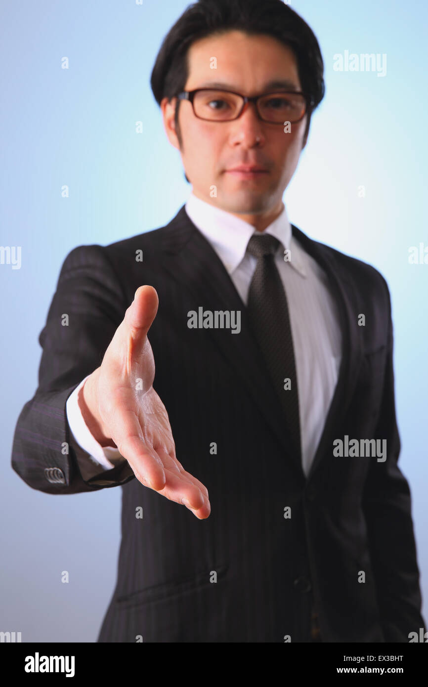 Japanese businessman giving hand Stock Photo - Alamy