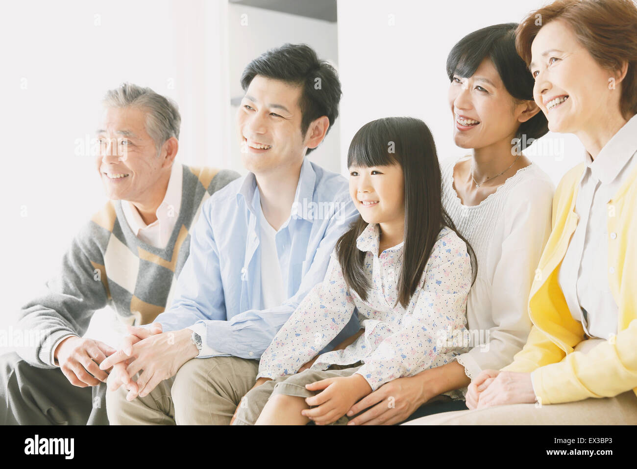 Three-generation Japanese family on the sofa in the living room Stock ...