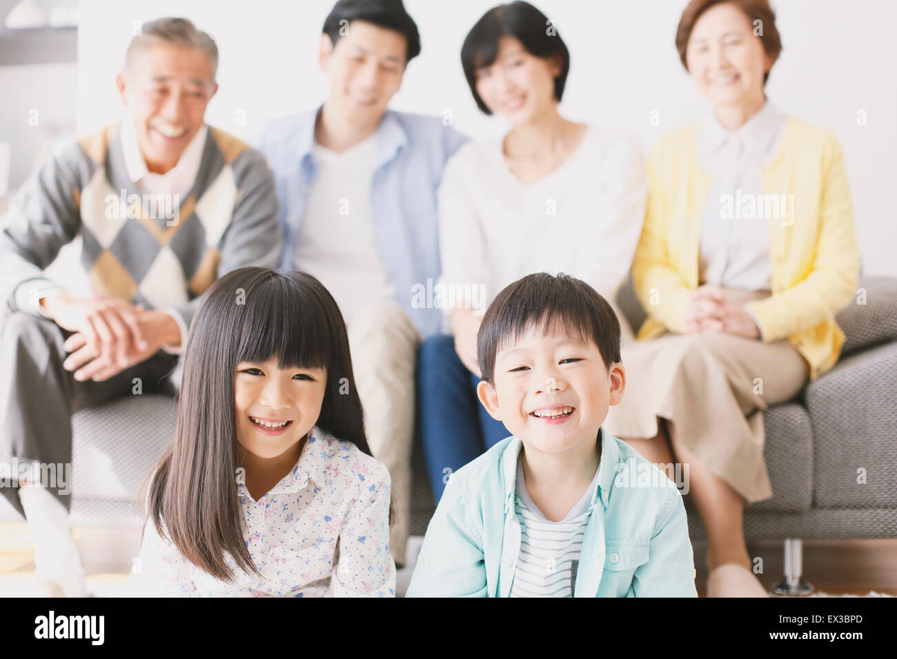 Three-generation Japanese family on the sofa in the living room Stock ...