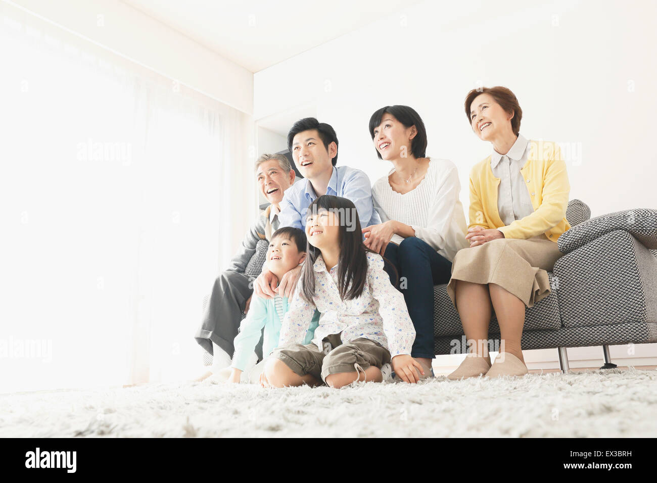 Three-generation Japanese family on the sofa in the living room Stock ...